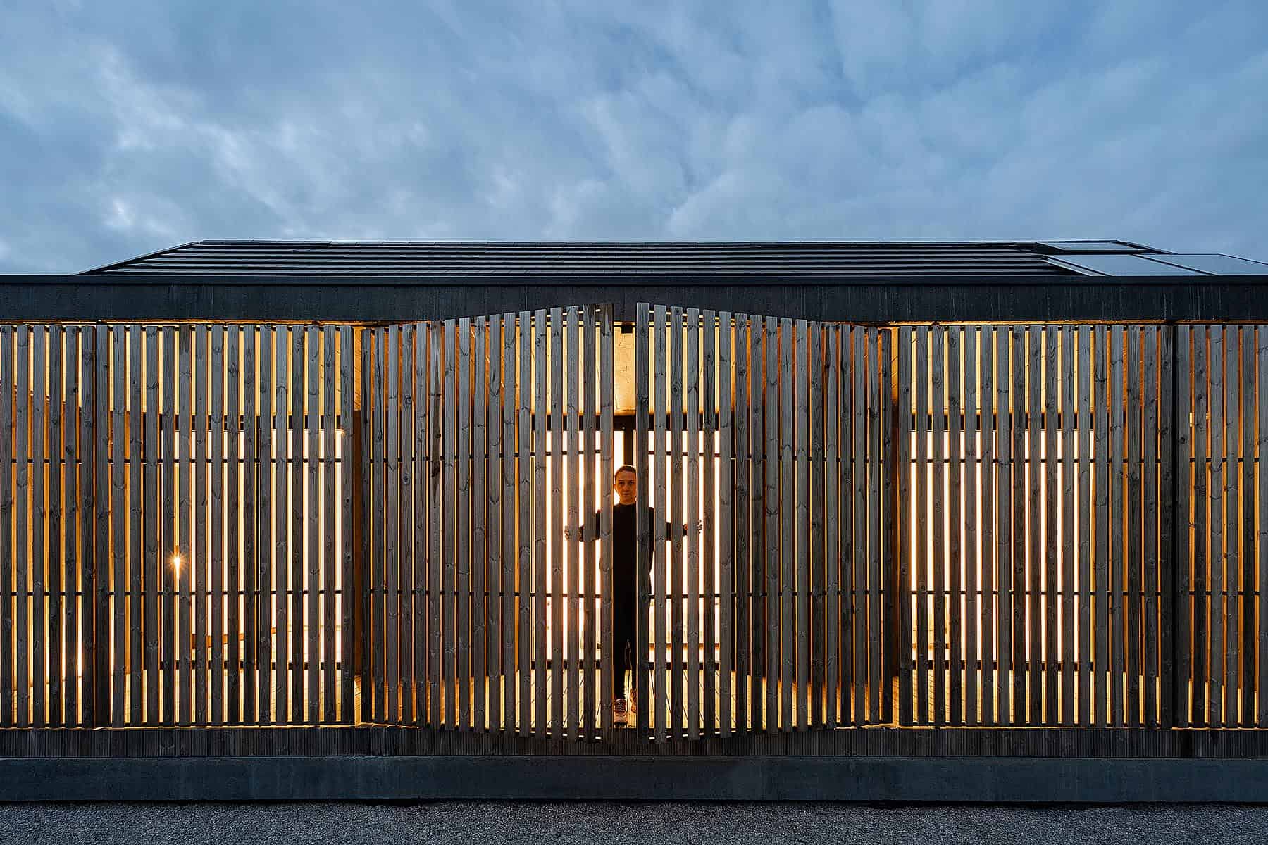 Opening the timber screens reveals a concrete House CG in Portugal