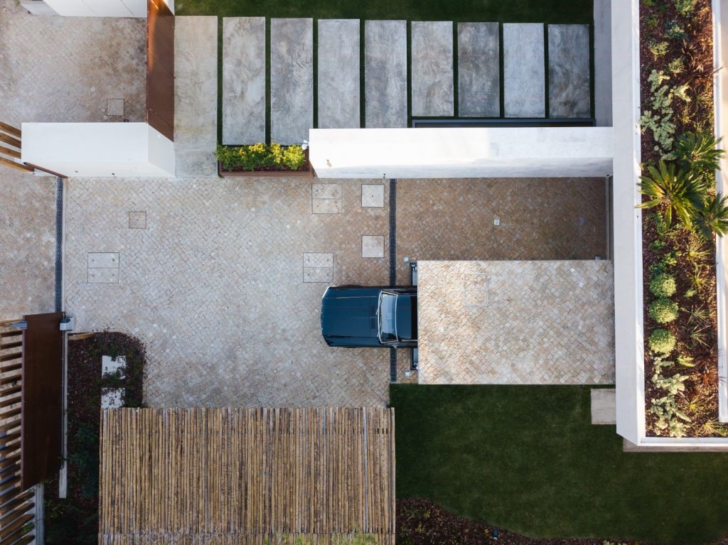 The disappearing car lift for a modern villa surrounded by nature in ...